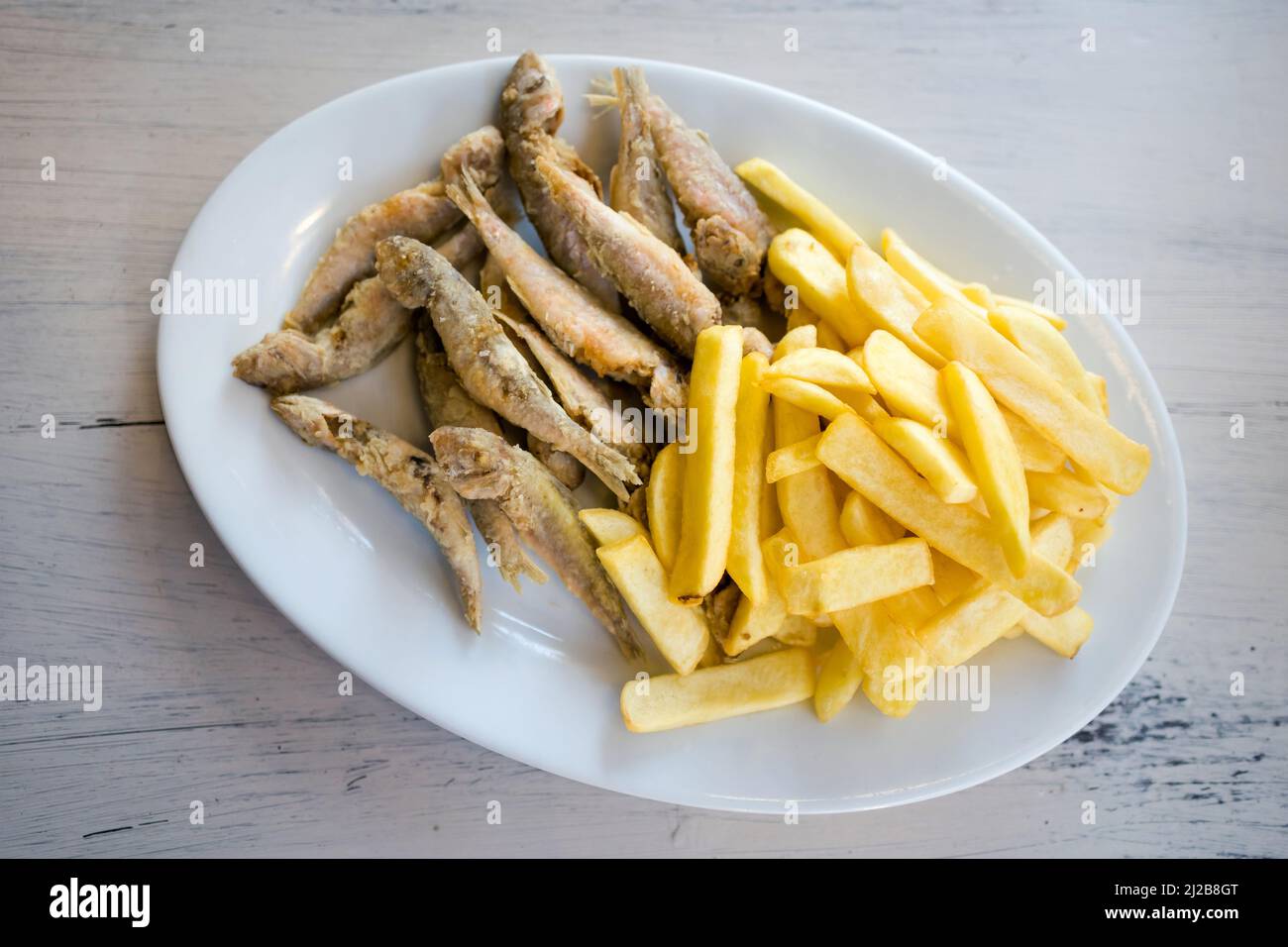 Delicious colorful local food fried fish with fries in a restaurant ...