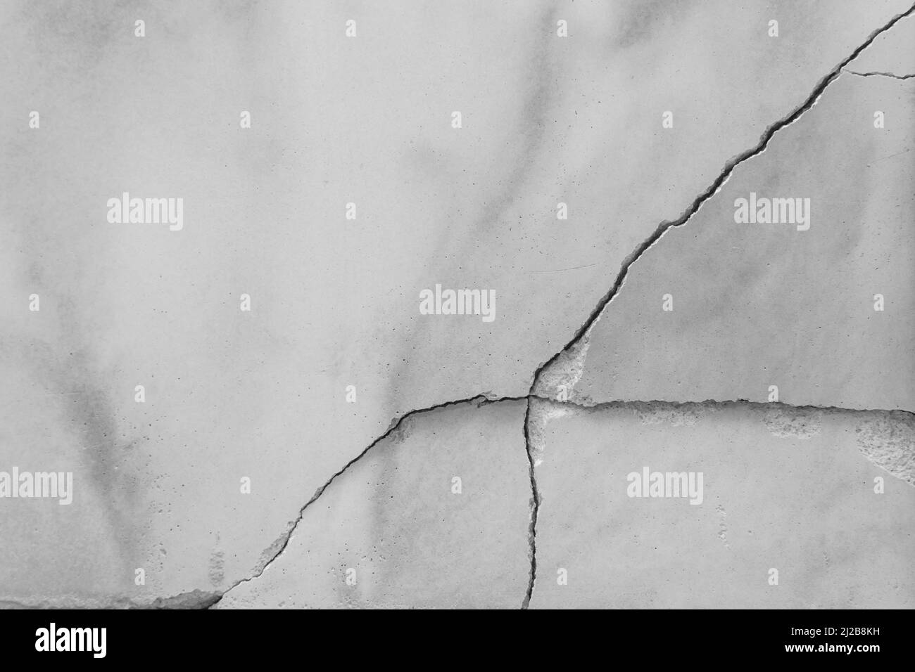 Broken cracked damaged stone tile wall surface in need of repair old ...