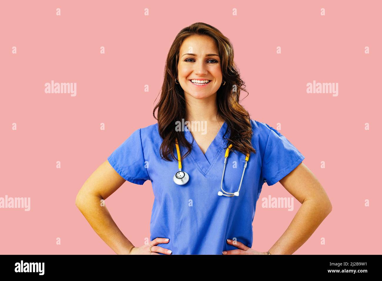 Portrait of smiling female doctor or nurse posing in blue uniform ...