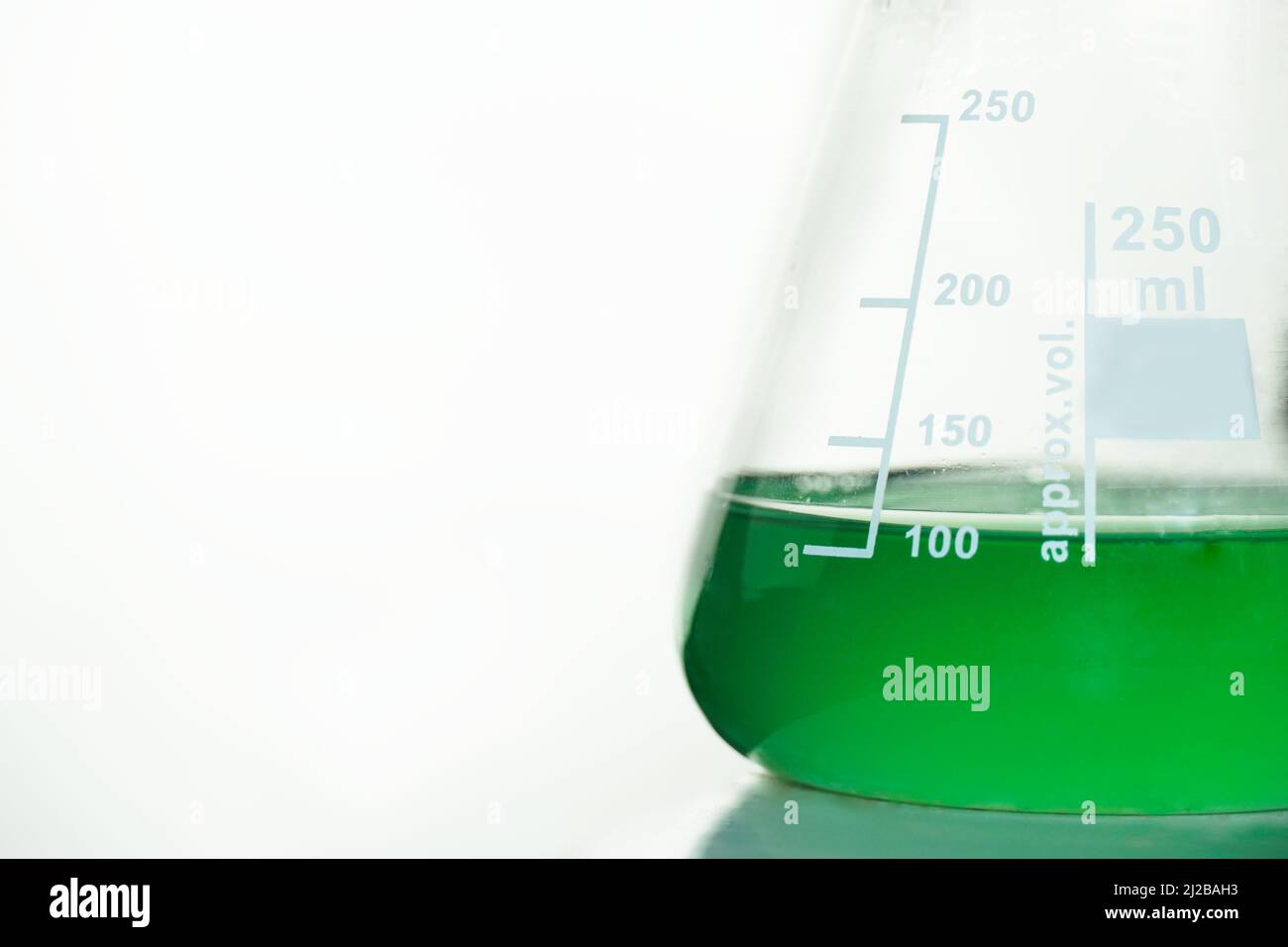 green nature solution in science glass flask at chemistry laboratory ...