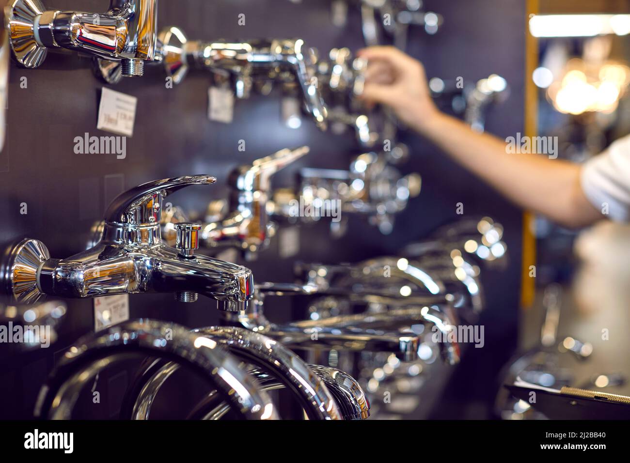 Close up shot of new shiny chrome faucets at a hardware store or a ...