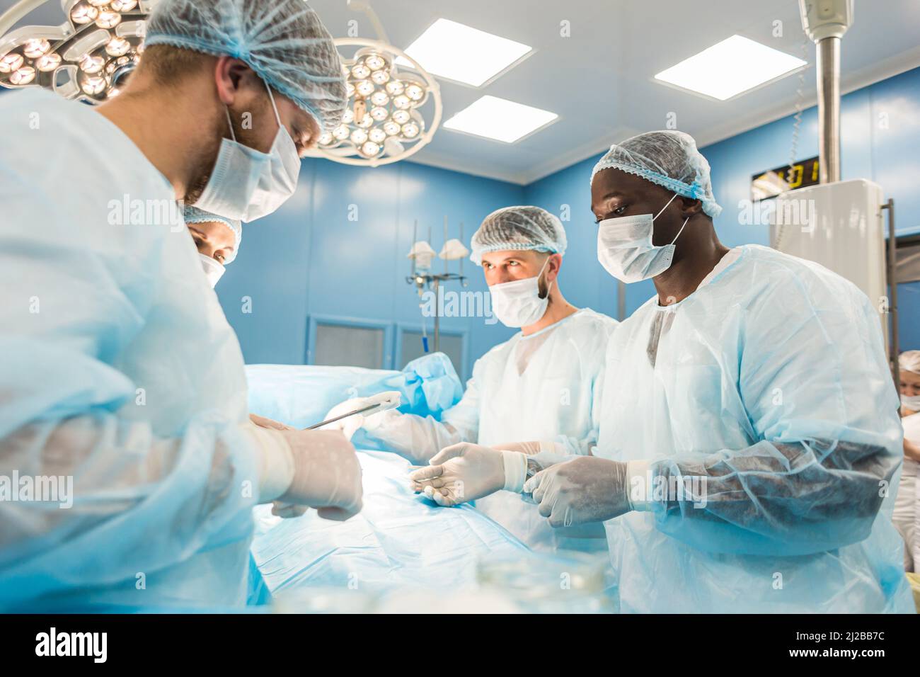 An international team of doctors performs a complex surgical operation ...