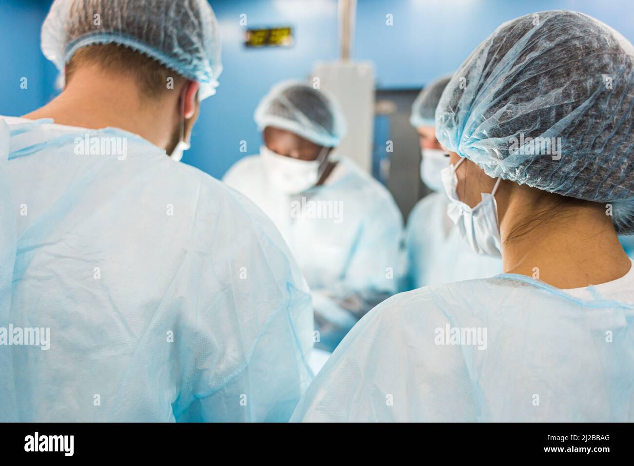 An international team of doctors performs a complex surgical operation ...