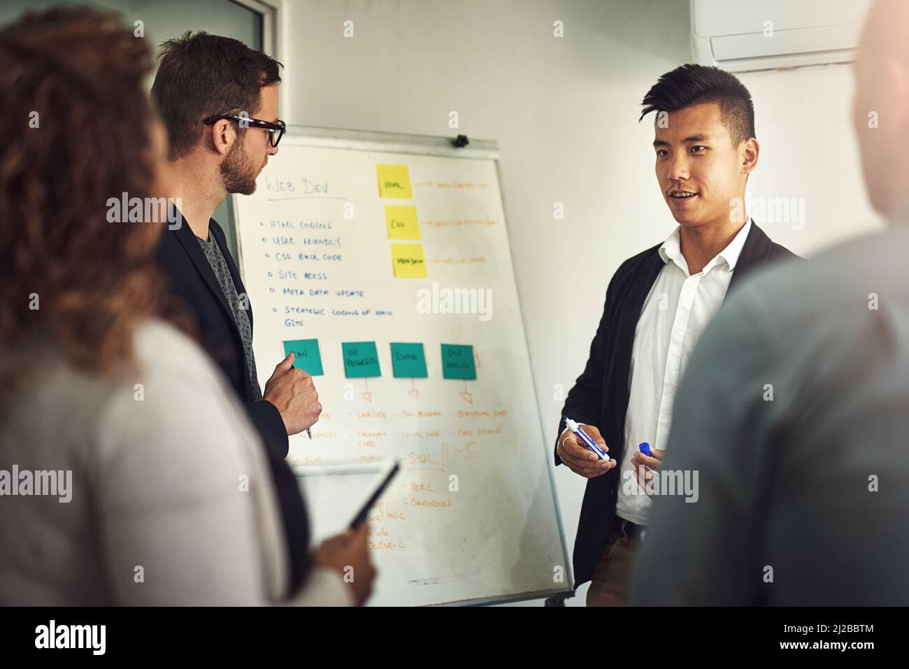 Young executive giving presentation on hi-res stock photography and ...