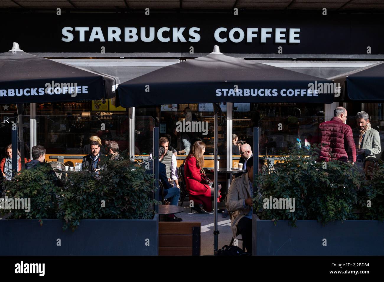 Customers are seen at the American multinational chain Starbucks Coffee ...