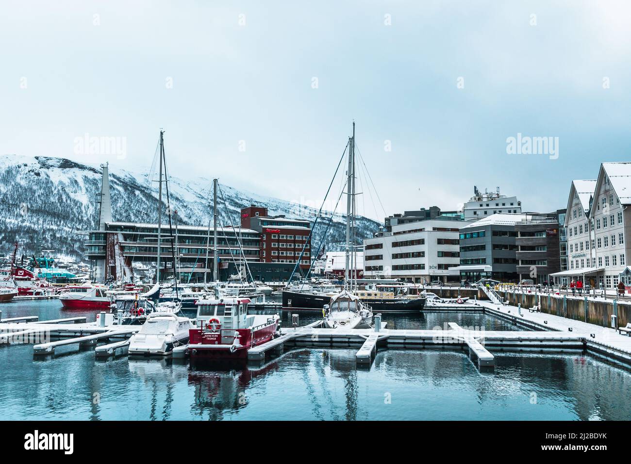 Tromso harbour, Norway, March 3rd 2022: Pier and traditional and new ...