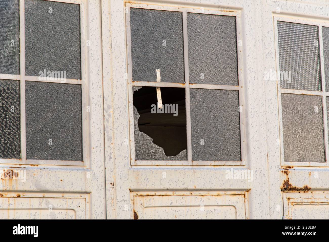Smashed window with broken window pane Stock Photo - Alamy