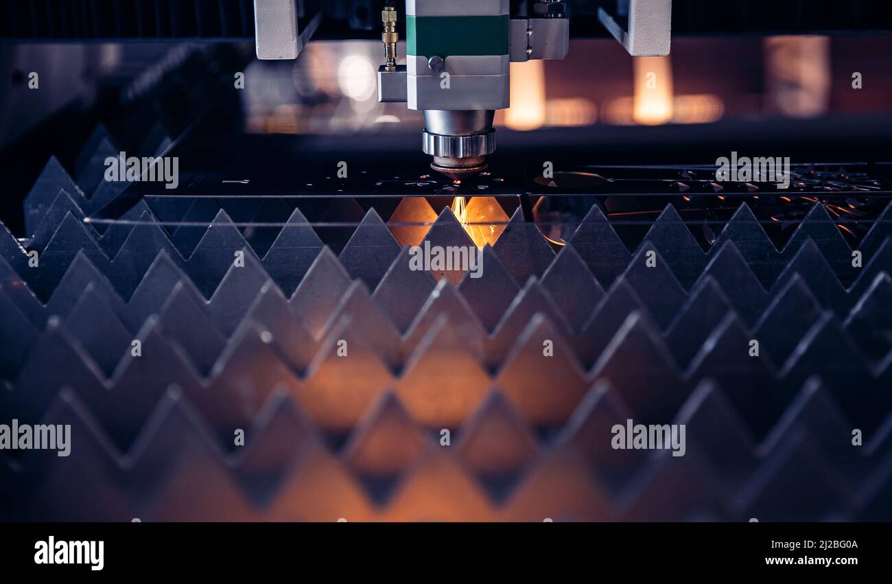 Blue color Laser CNC cut of metal with light spark, technology modern ...