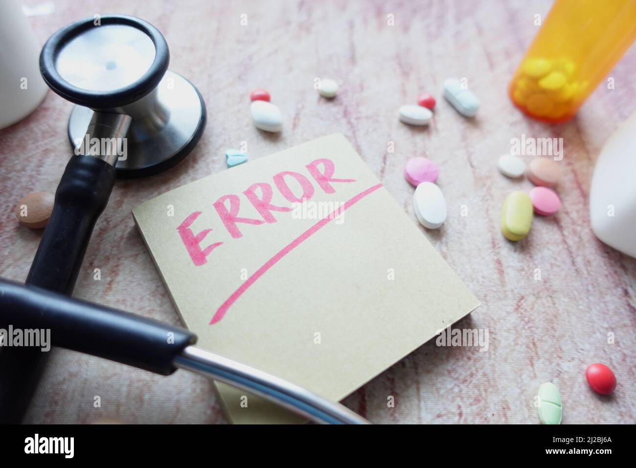 medical error text on a paper with pills and stethoscope on table Stock ...