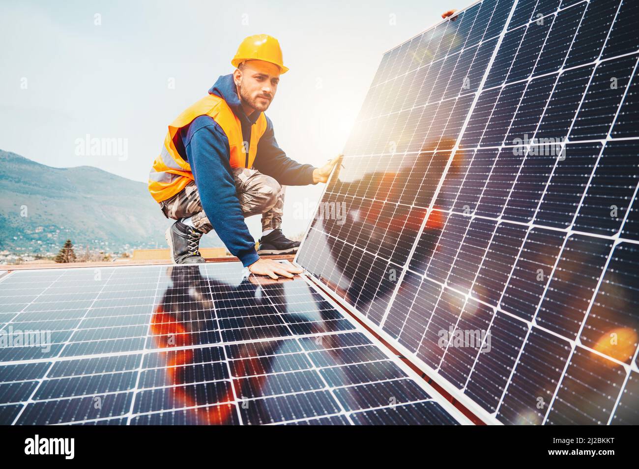 Workers assemble energy system with solar panel for electricity Stock ...