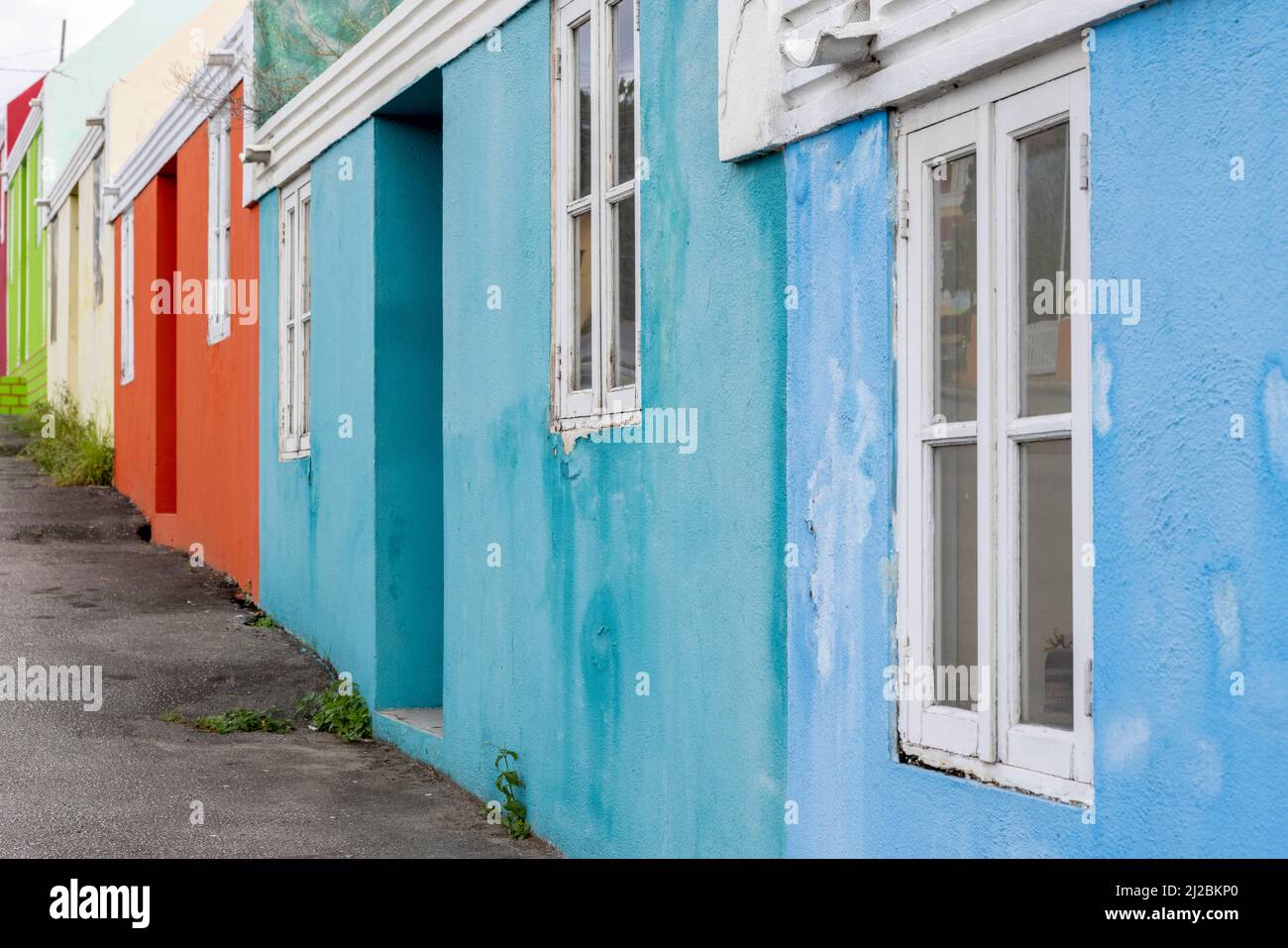Small colorful houses along the road somewhere in Willemstad, Curacao ...