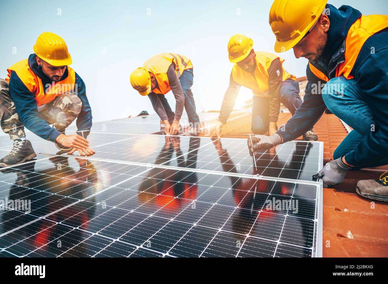 Workers assemble energy system with solar panel for electricity Stock ...