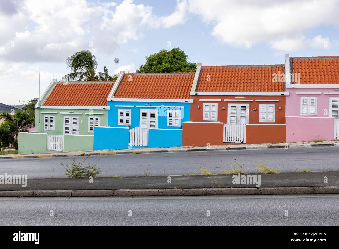 Small colorful houses along the road somewhere in Willemstad, Curacao ...