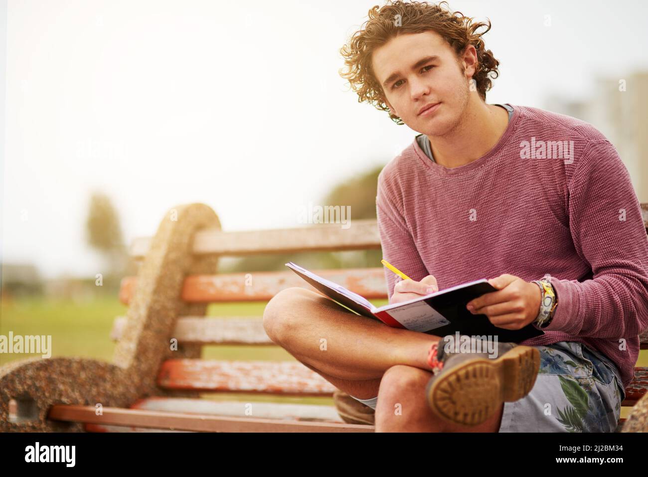 Theres always time for a bit of studying. Portrait of a young man ...