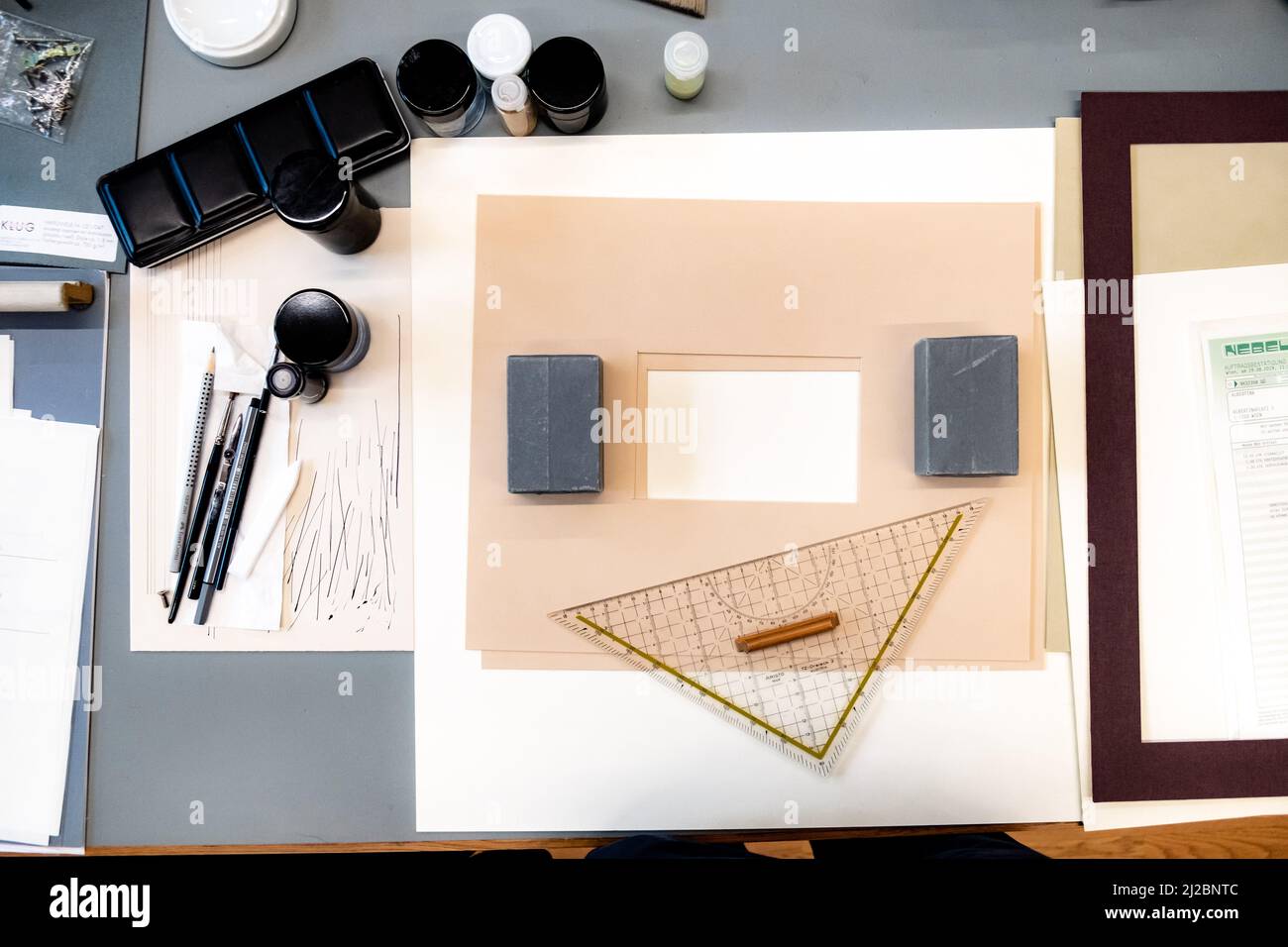 A selection of drawing materials including triangle ruler, shower pen ...