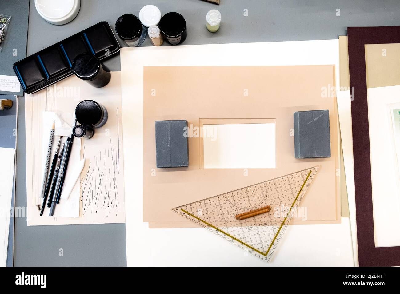 A selection of drawing materials including triangle ruler, shower pen ...