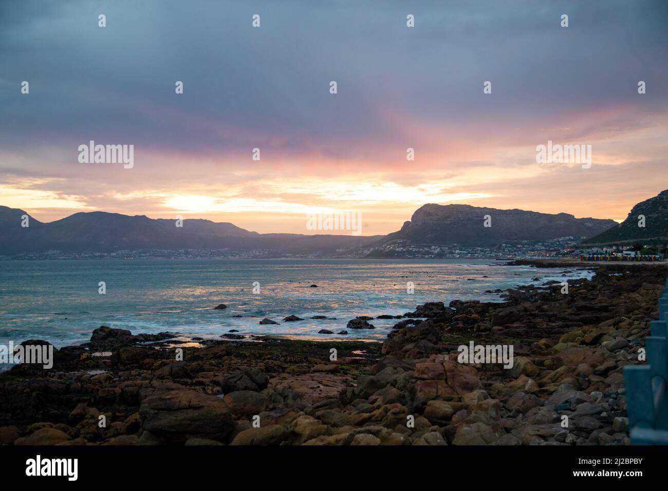 A beautiful shot of a sunset sky over Kalk Bay in Muizenburg, South ...