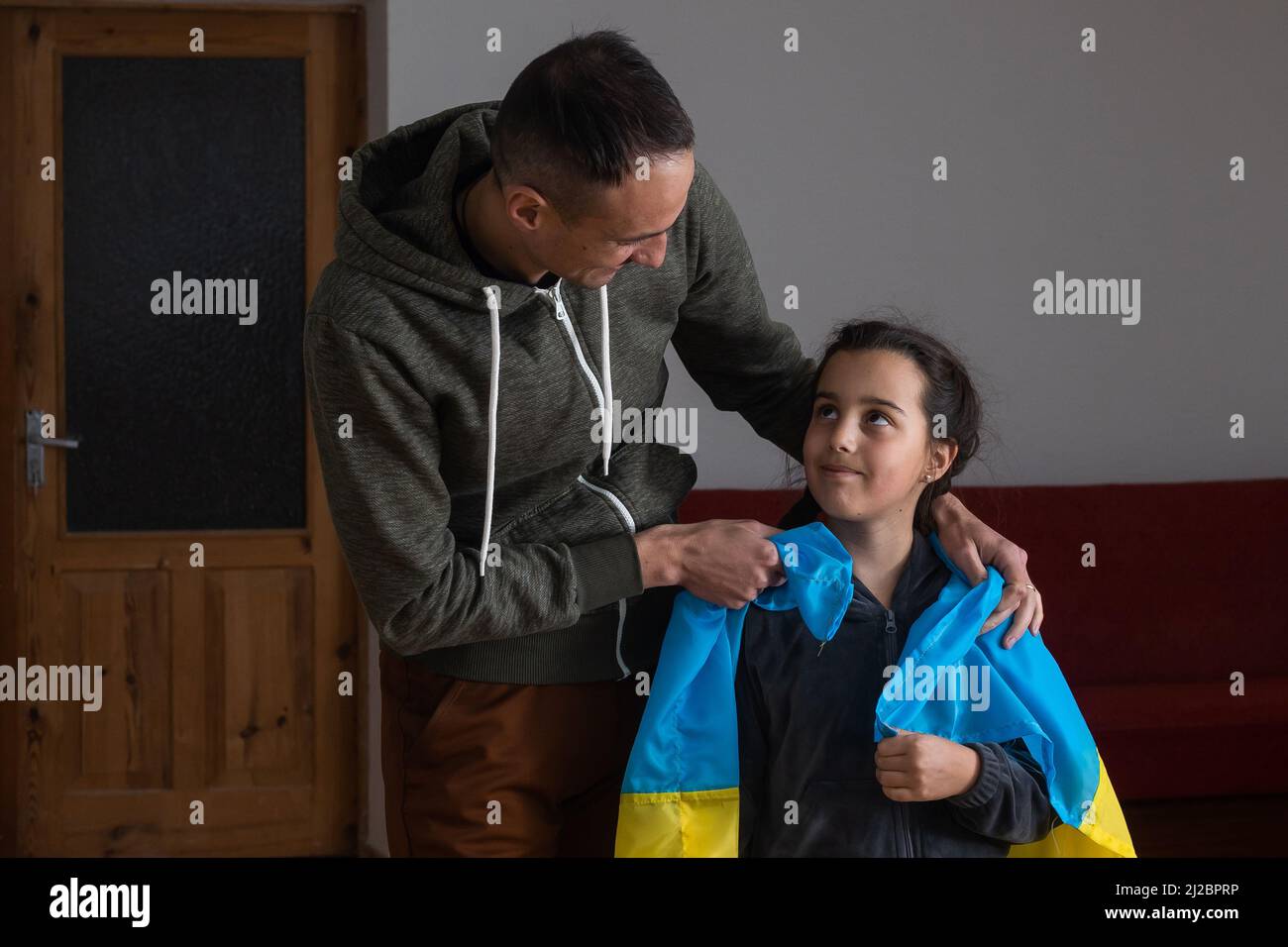 Ukrainian flag. Father with daughter at home Stock Photo - Alamy