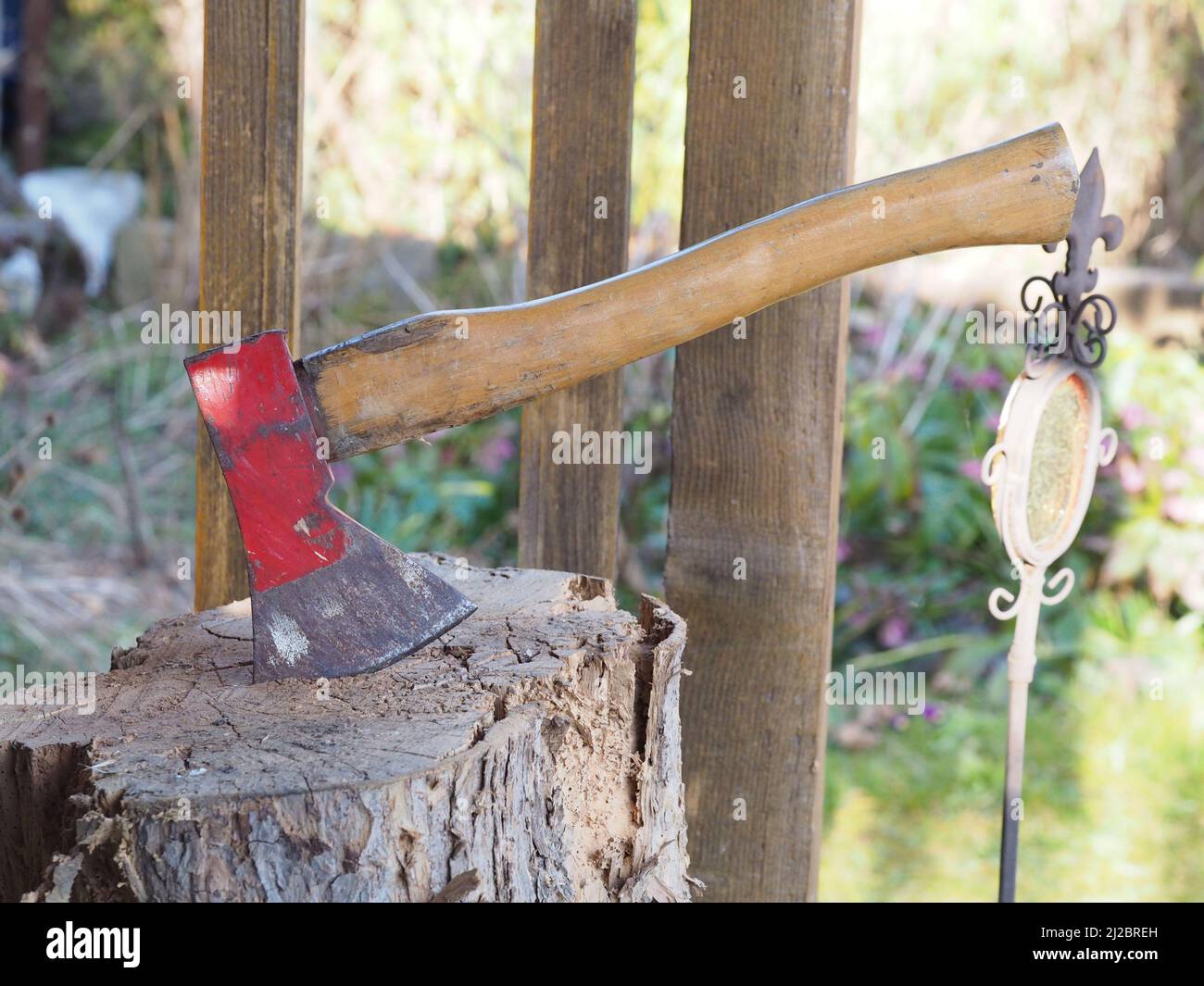 An old axe stuck in a wood log Stock Photo - Alamy