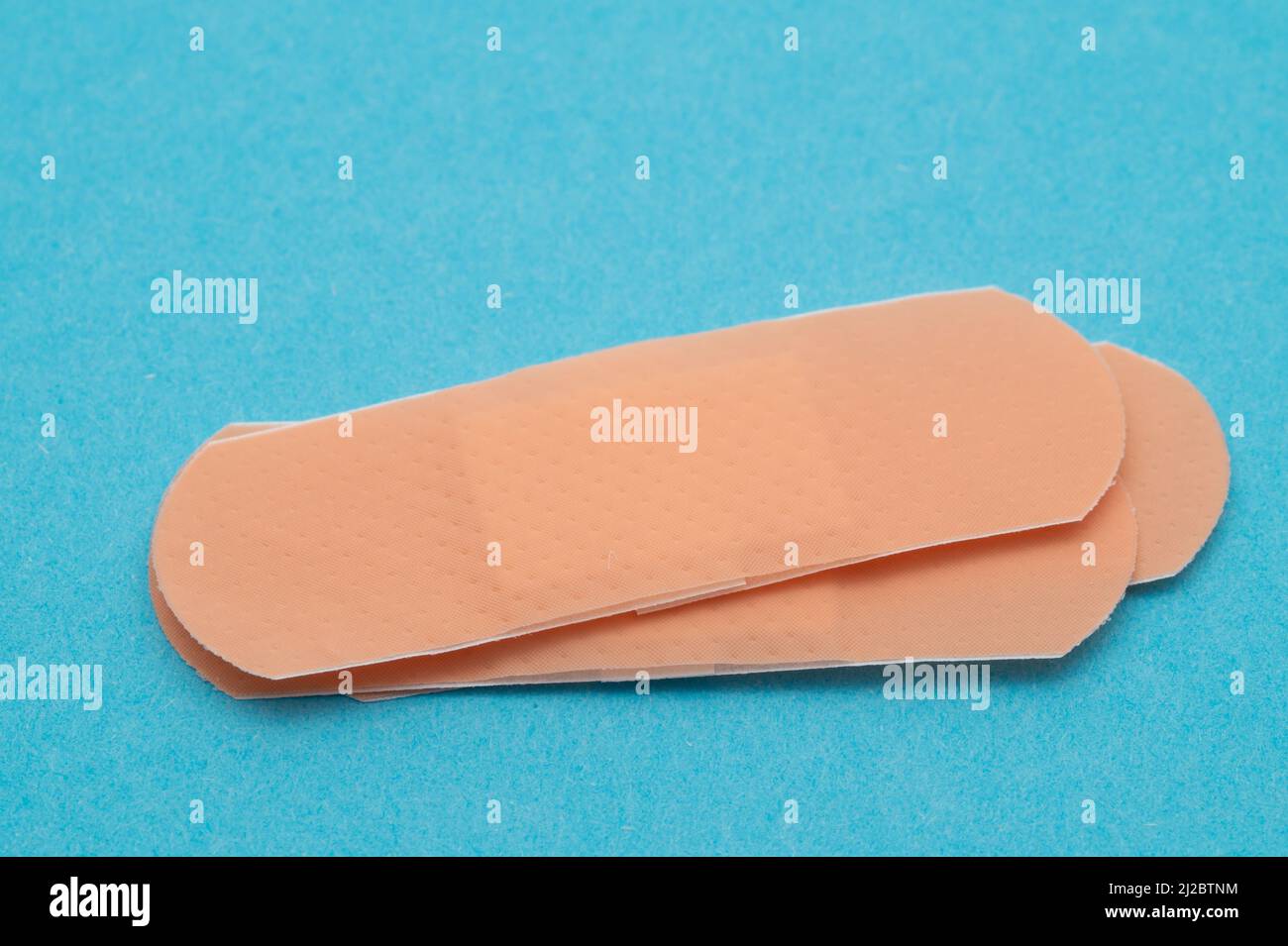 medical plaster on a blue background Stock Photo - Alamy