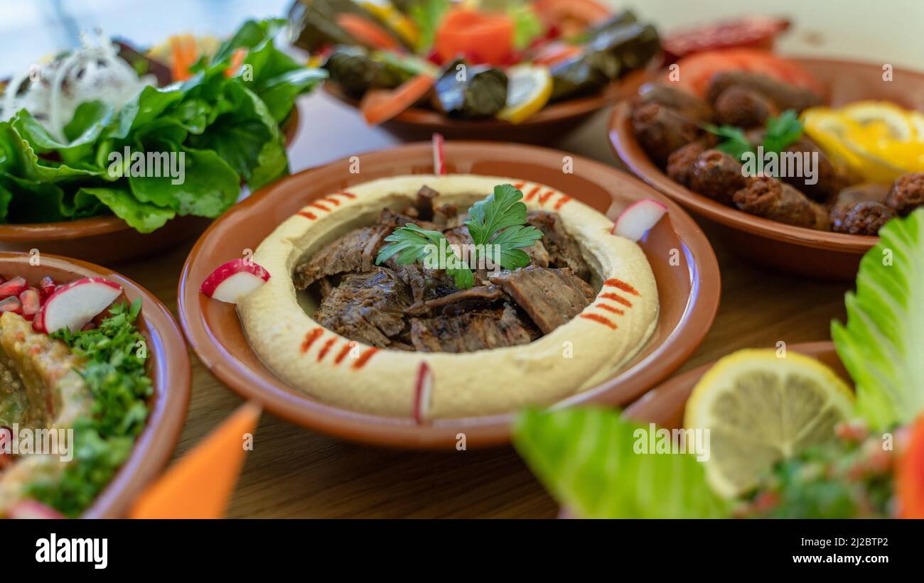 Multiple lebanese appetizers and salads togeather on the table. focused ...