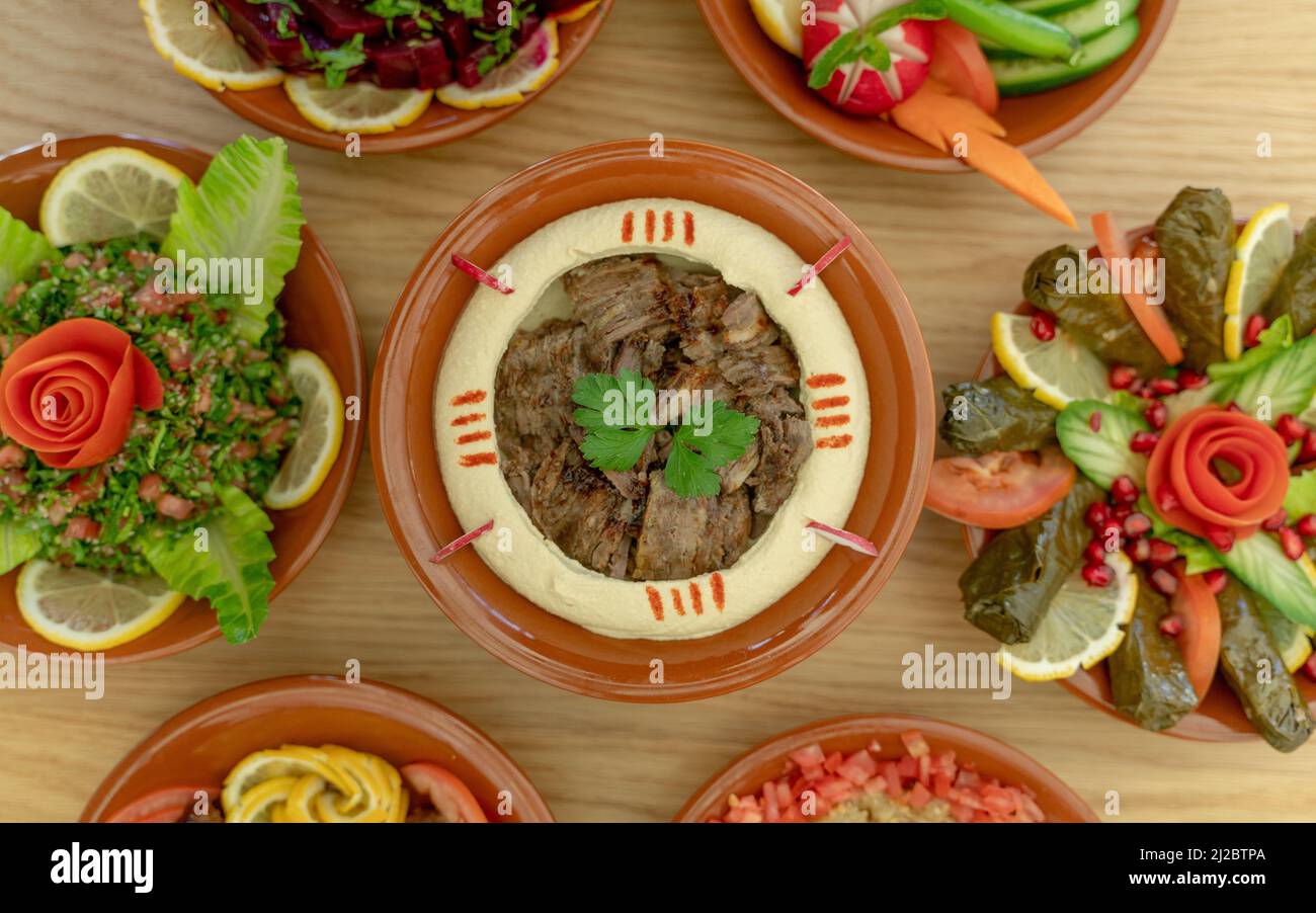 Multiple lebanese appetizers and salads togeather on the table. focused ...