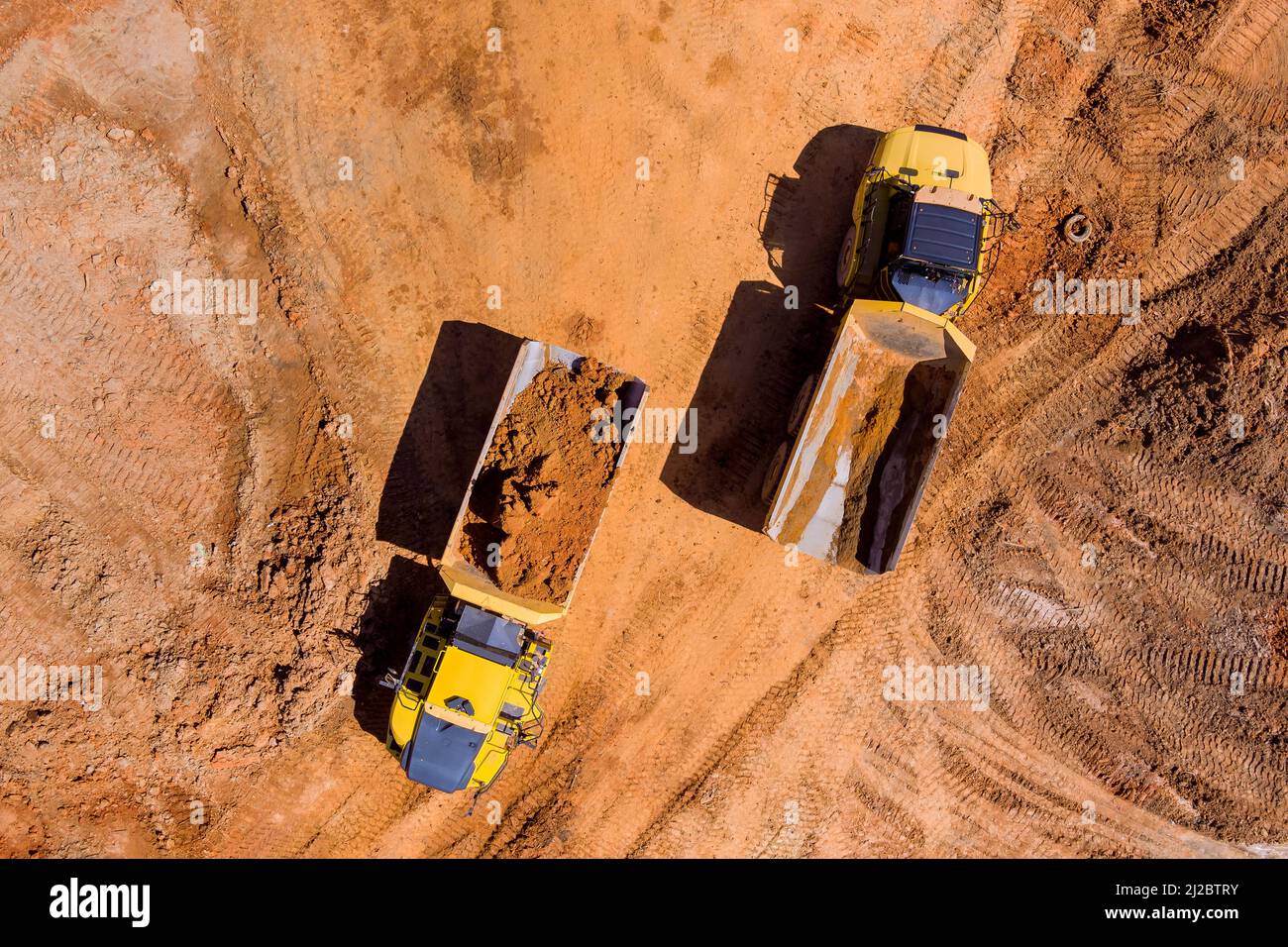 Aerial top view of earth moving heavy equipment at construction site ...