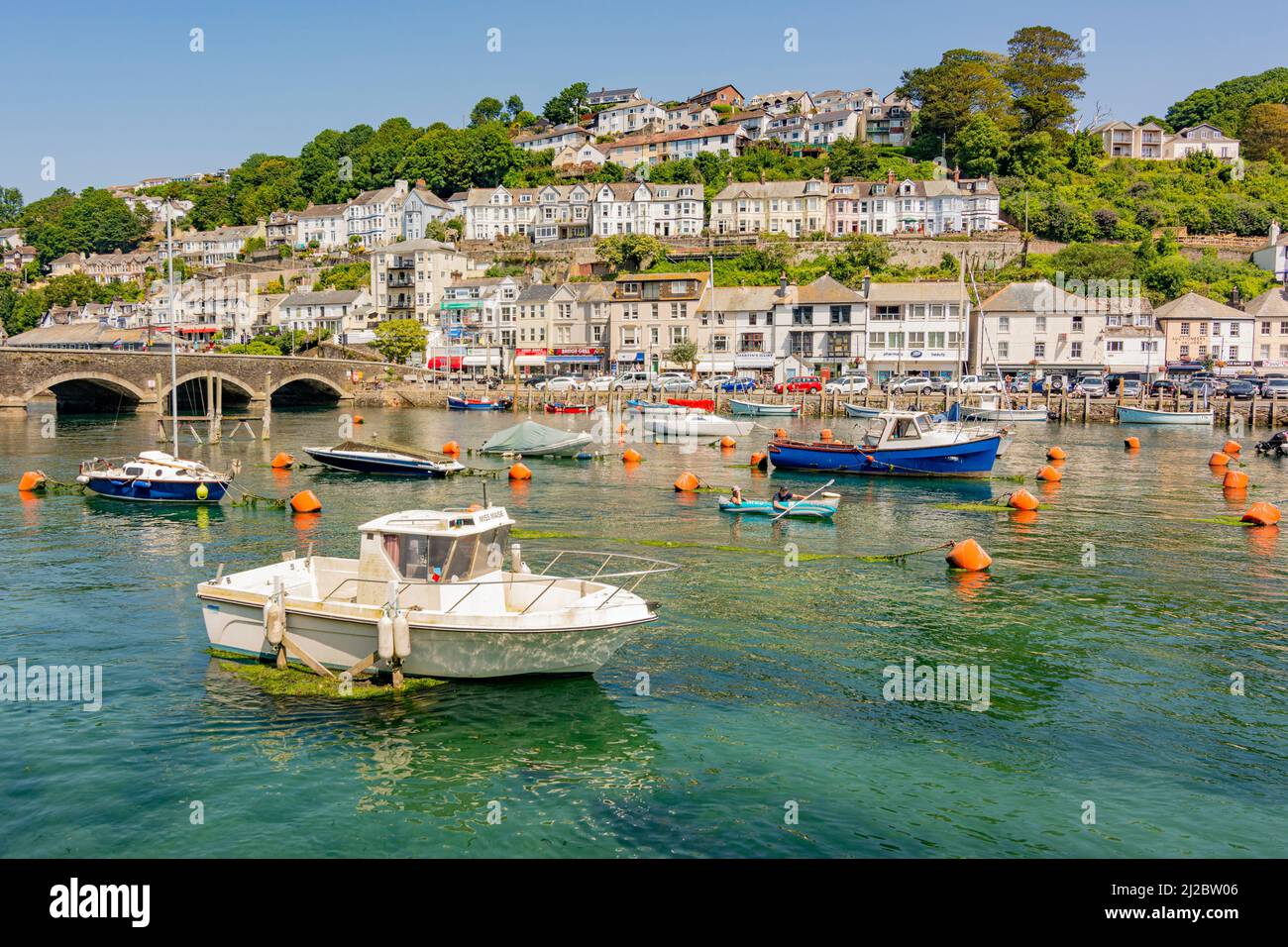 Looking over the East Looe River to East Looe dwellings and shops on a ...