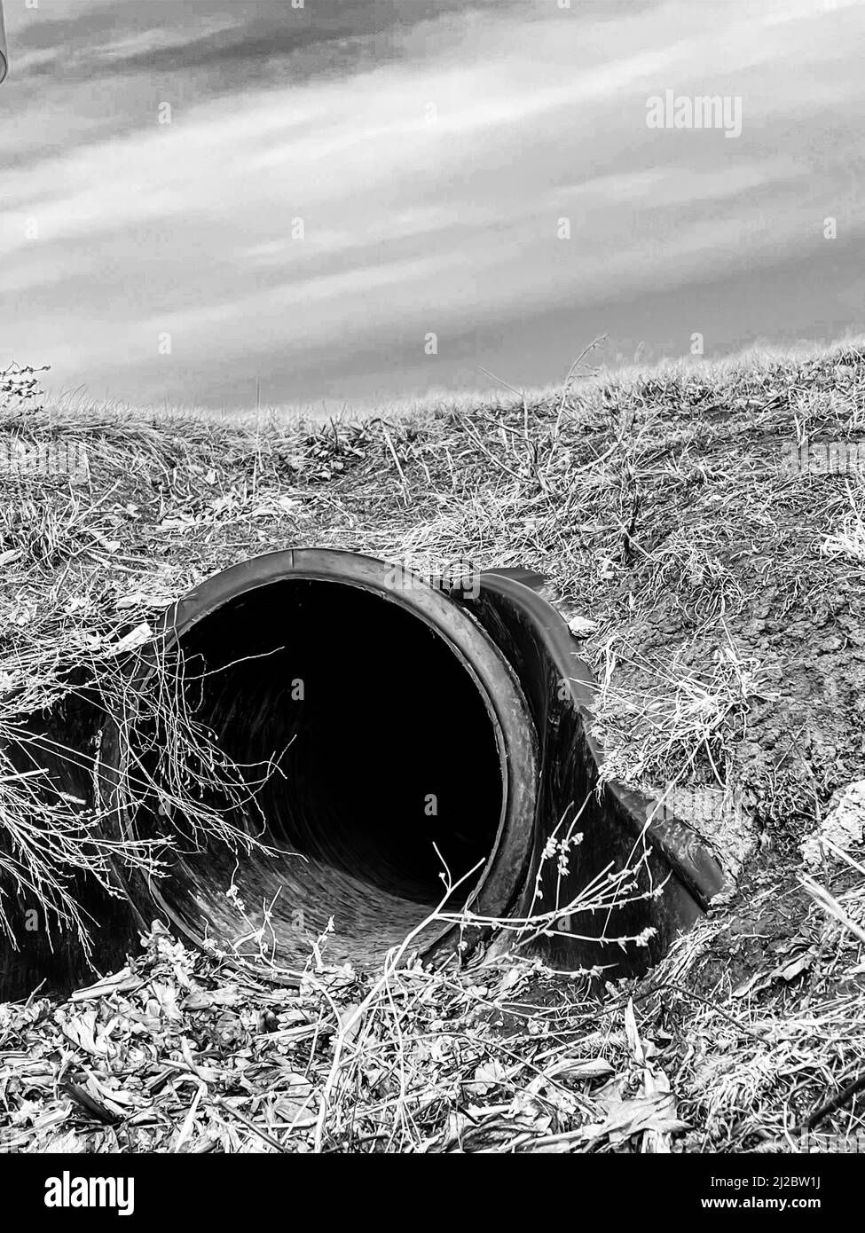 HDPE drainage culvert under a road entrance. Pipe is used to convey ...