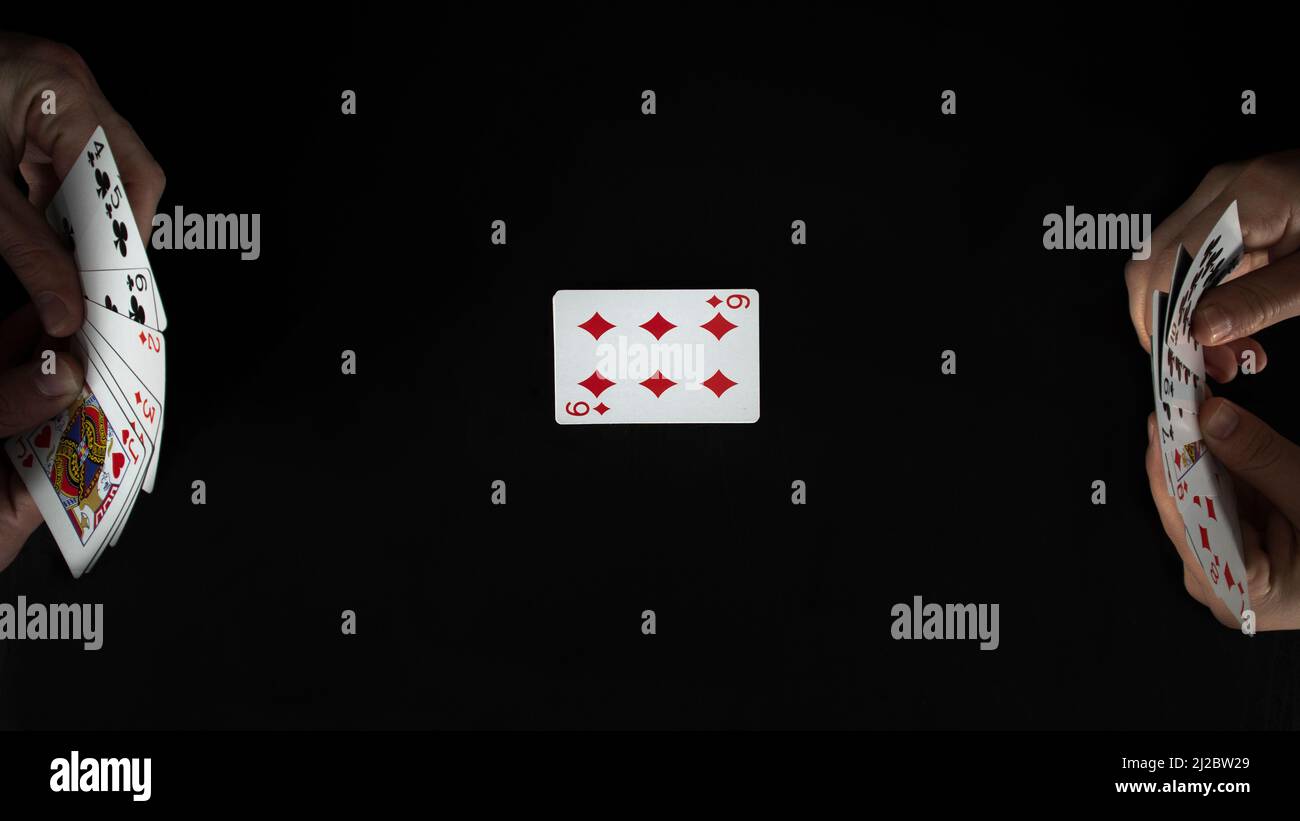 Two persons playing cards, gambling on table, diamond at the top of ...