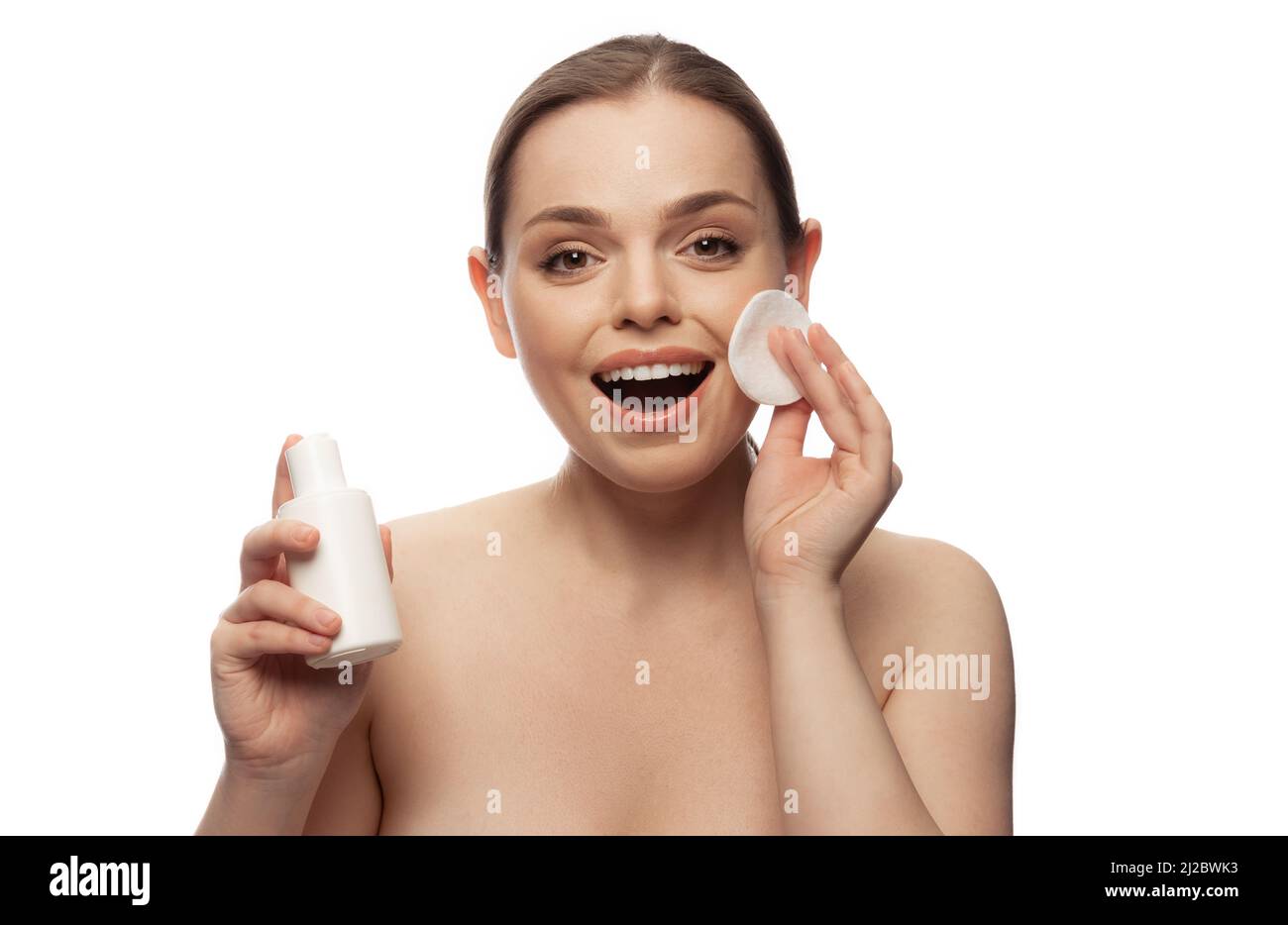 Portrait of beautiful emotive woman with natural looking skin, applying ...