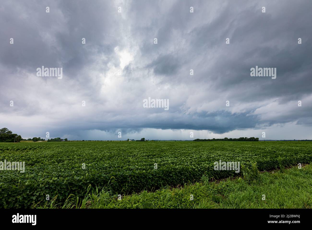 Thunderstorm with dark clouds moving across farm fields. Severe weather ...