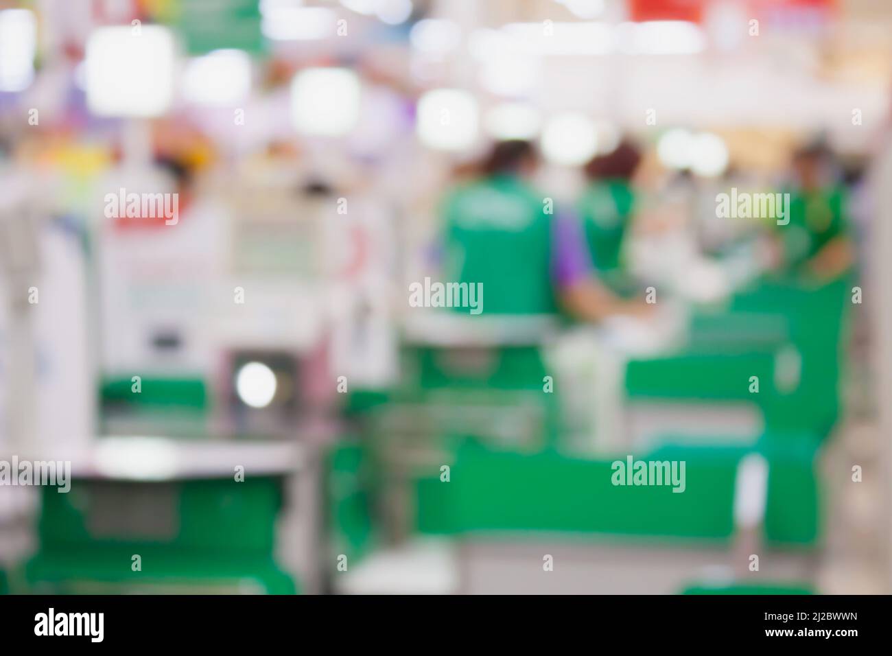 supermarket checkout payment terminal with customers blurred background ...