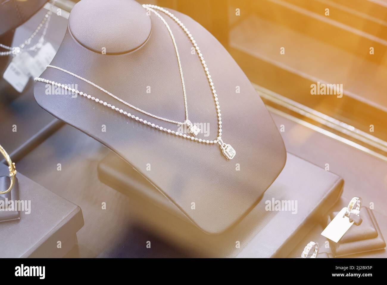 Jewelry diamond necklace in jewelry shop store window display showcase ...