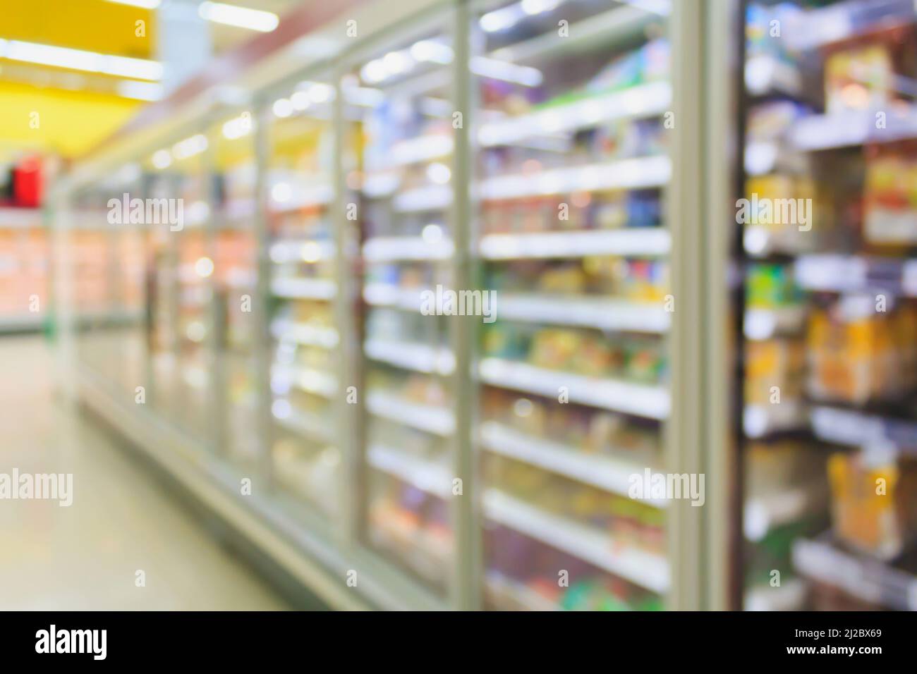 Frozen food section in supermarket blurred background Stock Photo - Alamy