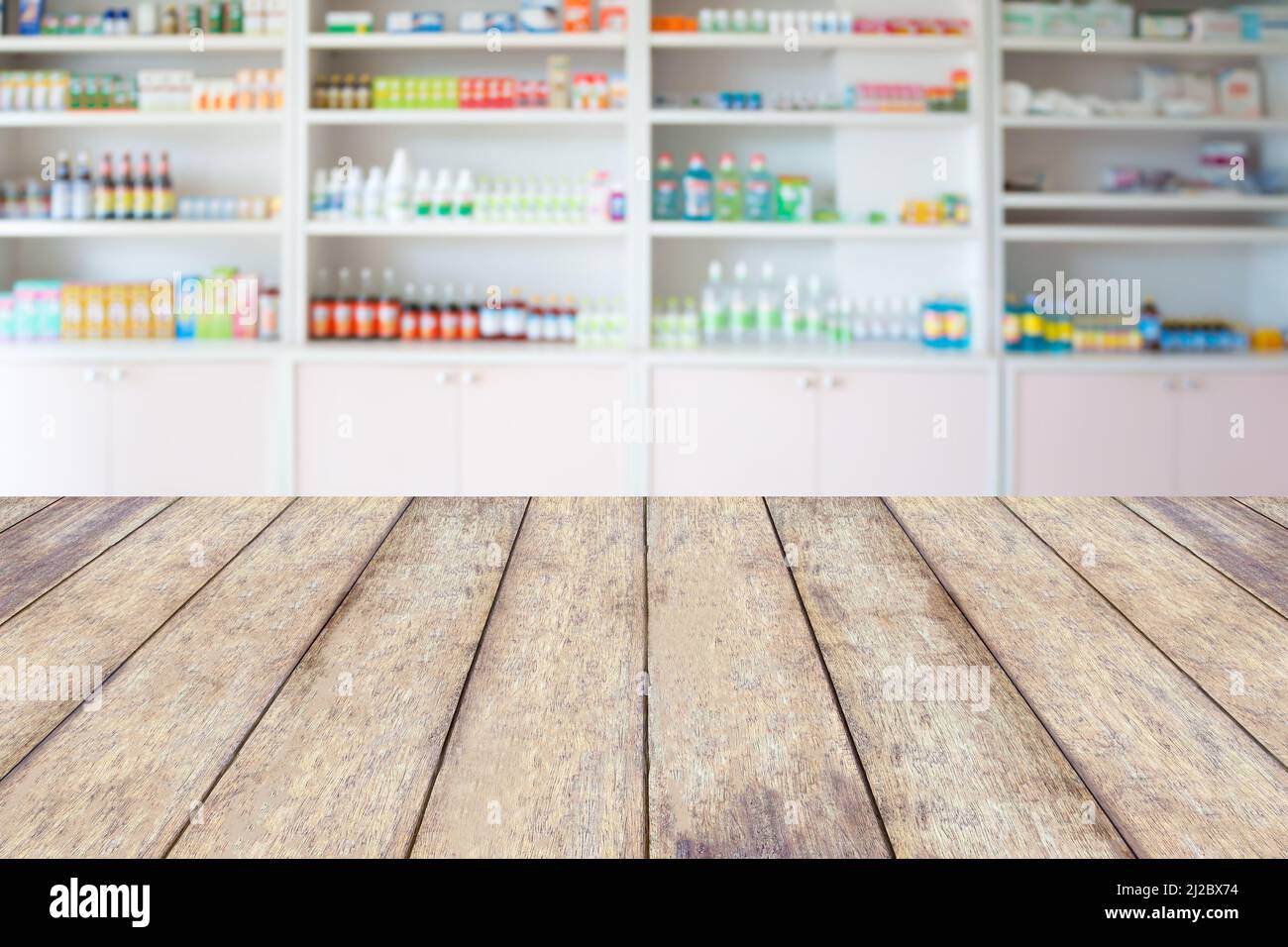 pharmacy wood counter with blur shelves of drug in the pharmacy ...