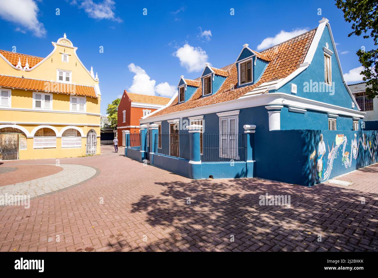 beautiful blue building with artwork on the right wall in Willemstad ...