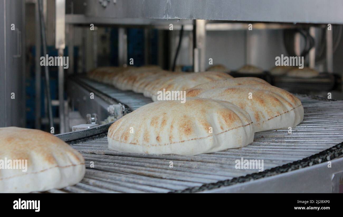 Making arabic bread khabuz in the machine Stock Photo - Alamy