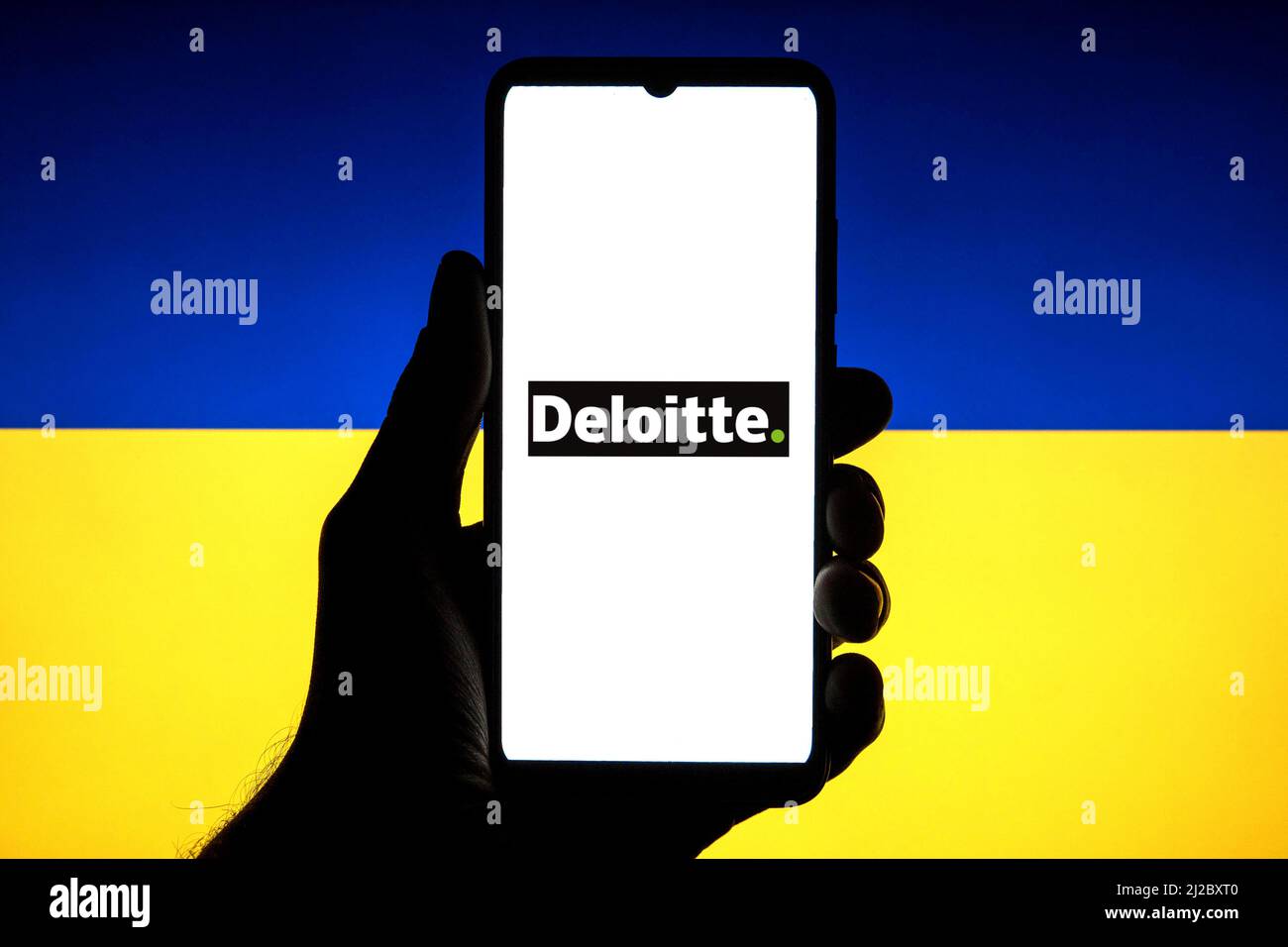 In this photo illustration a Deloitte logo seen displayed on a ...