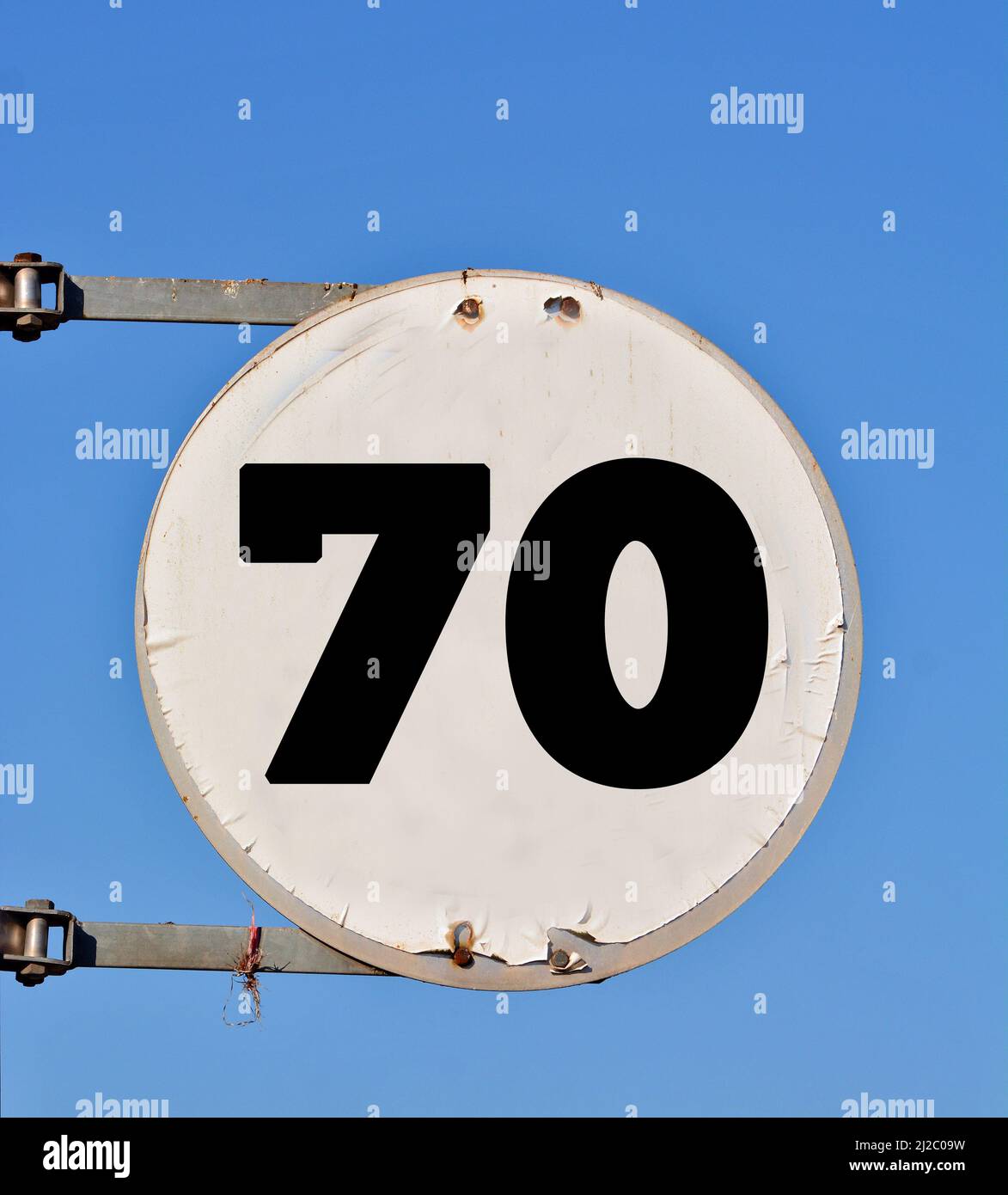 A speed limitation road sign "70" against the blue sky Stock Photo - Alamy
