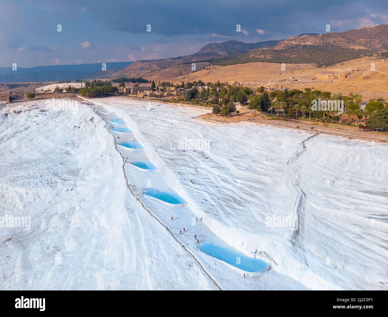 Natural travertine pools blue water in Pamukkale Turkey drone aerial ...
