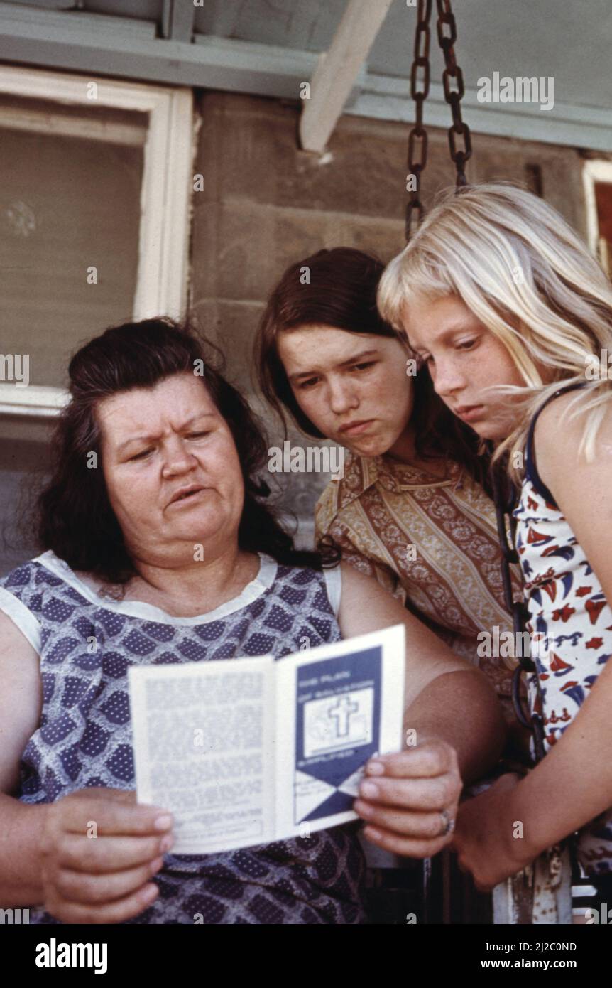 Mrs. May Watkins, daughter, Bertha, center, and a playmate look over a ...
