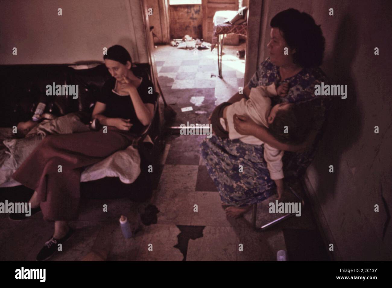 A mother sits in her Mulkey Square house with the youngest of her nine ...