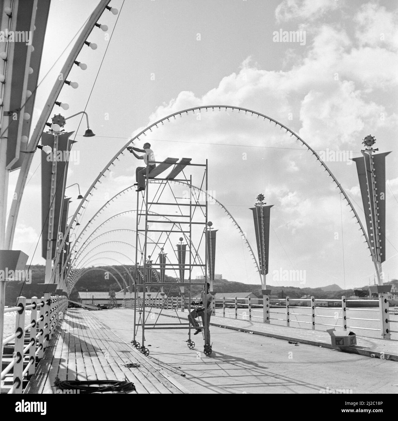 Decorating the Emma Bridge in Willemstad ca. October 1955 Stock Photo ...