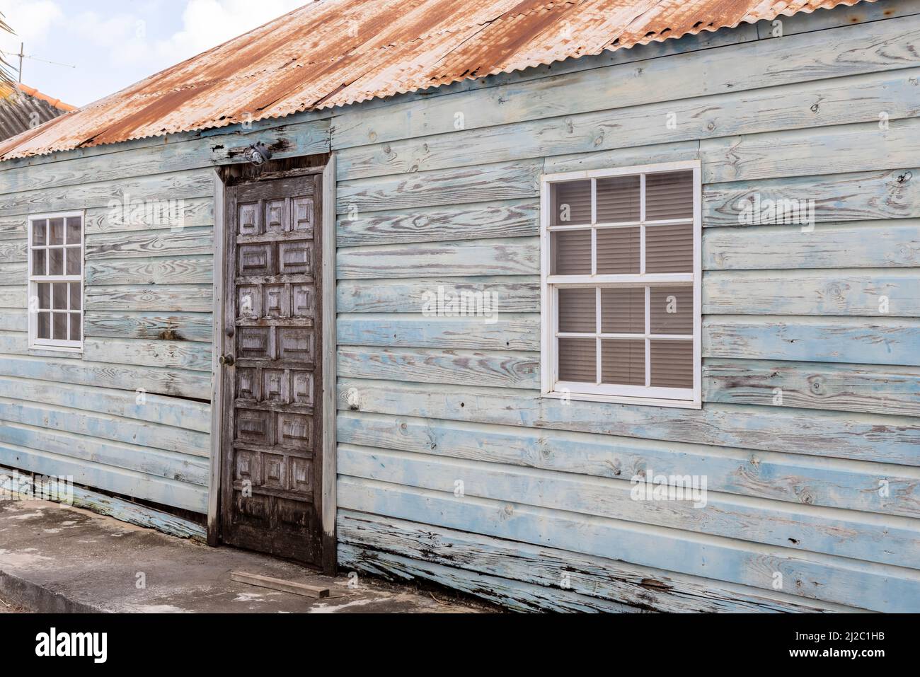 Small house with a weathered facade and a rusty roof in the suburbs of ...