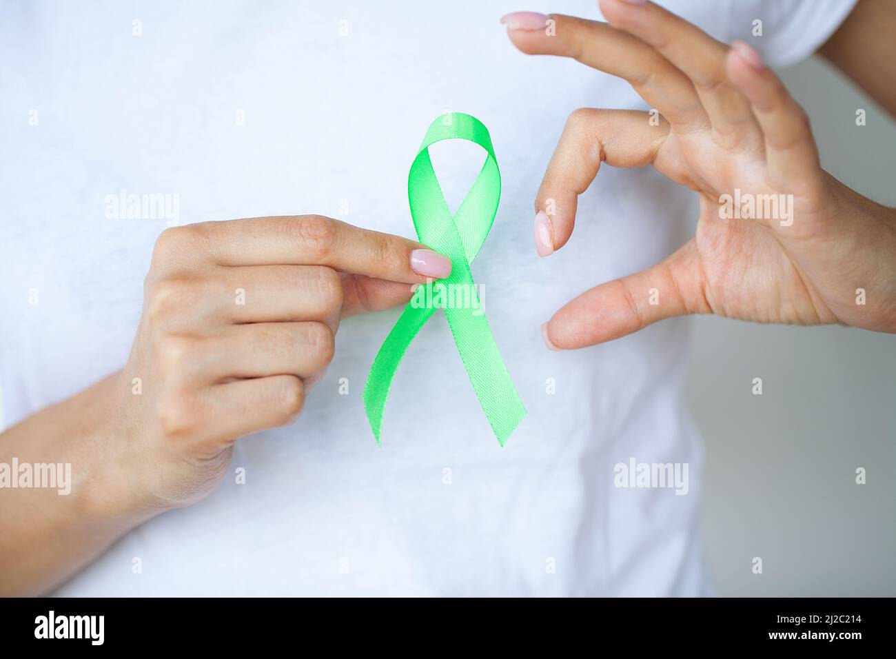 Doctor in uniform holds a green ribbon as a symbol of Lyme disease ...