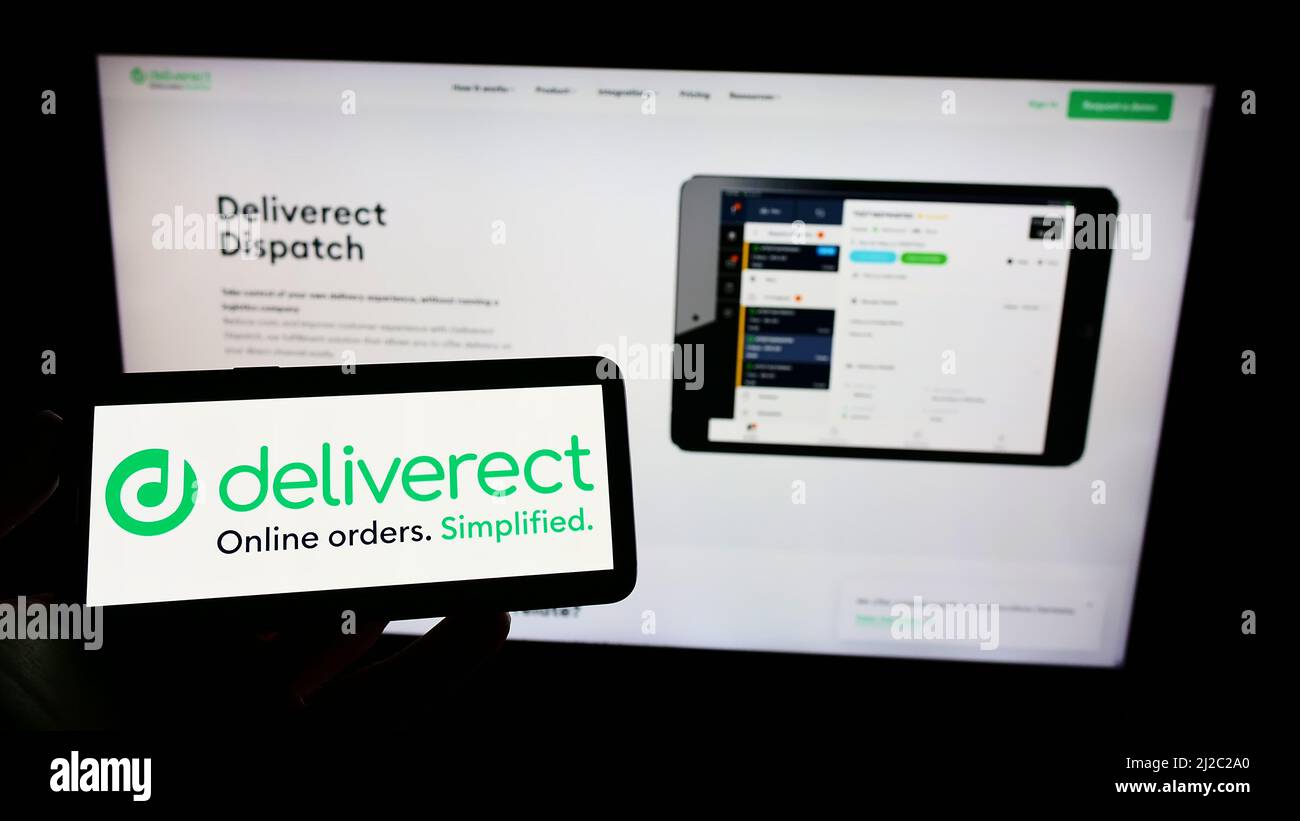 Person holding cellphone with logo of Belgian foodtech company ...