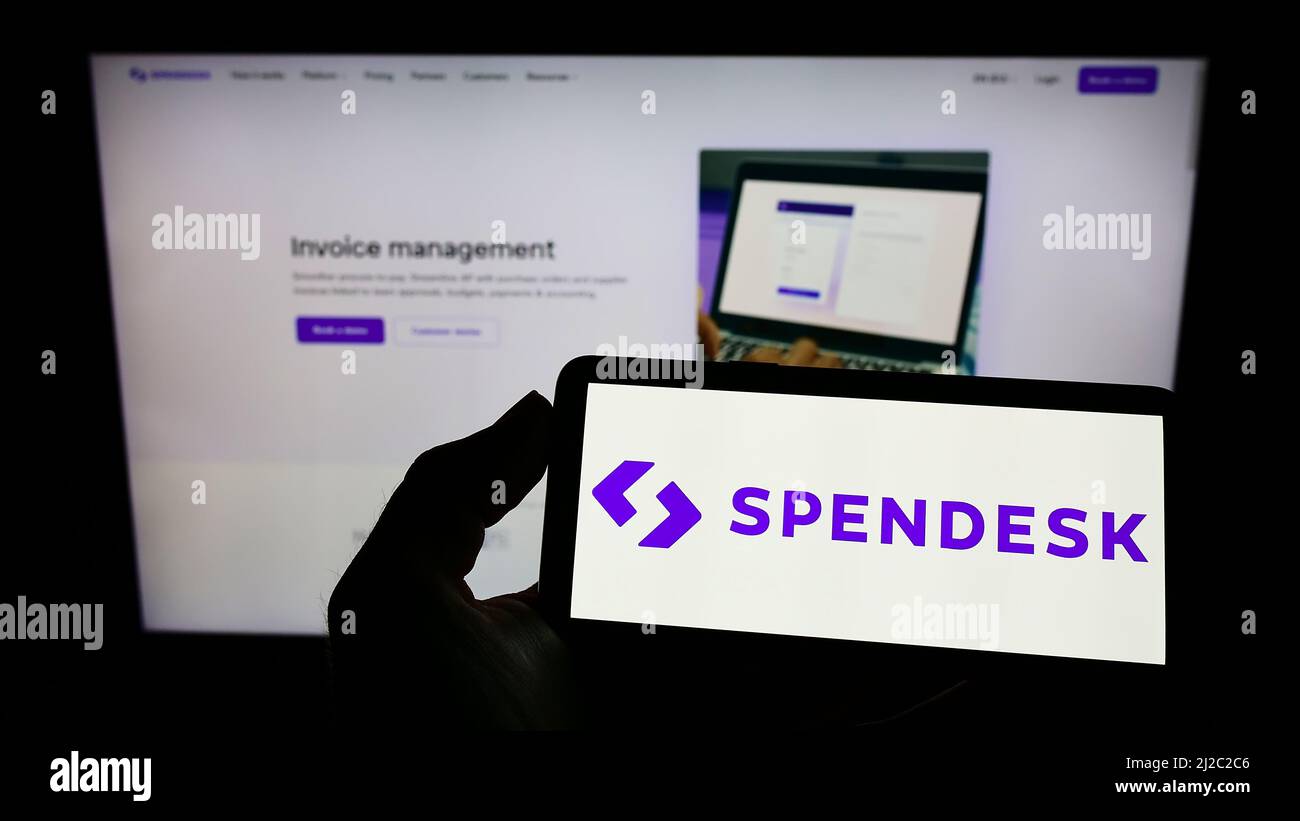 Person holding mobile phone with logo of French fintech company ...