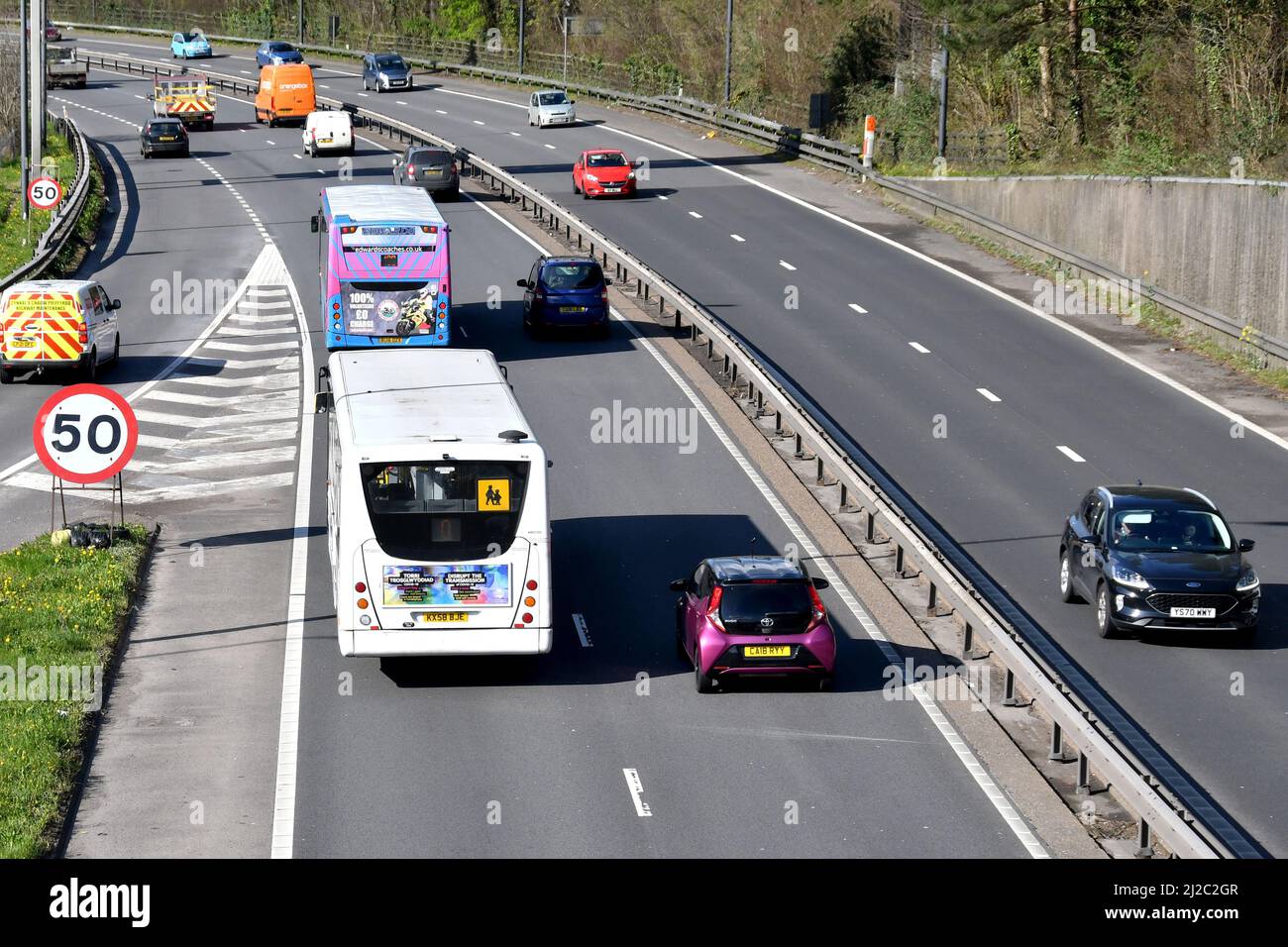 Taffs Well, near Cardiff, Wales - March 2022: Buses and other vehicles ... Taffs Well, near Cardiff, Wales - March 2022: Buses and other vehicles ...