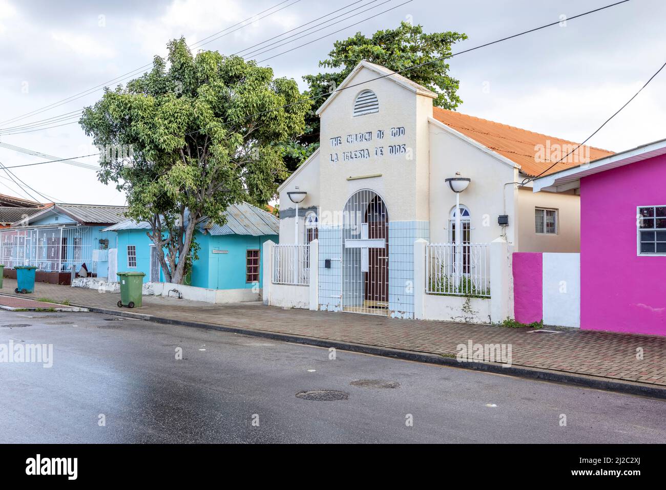 small church amidst colorful houses in the suburbs of Willemstad ...